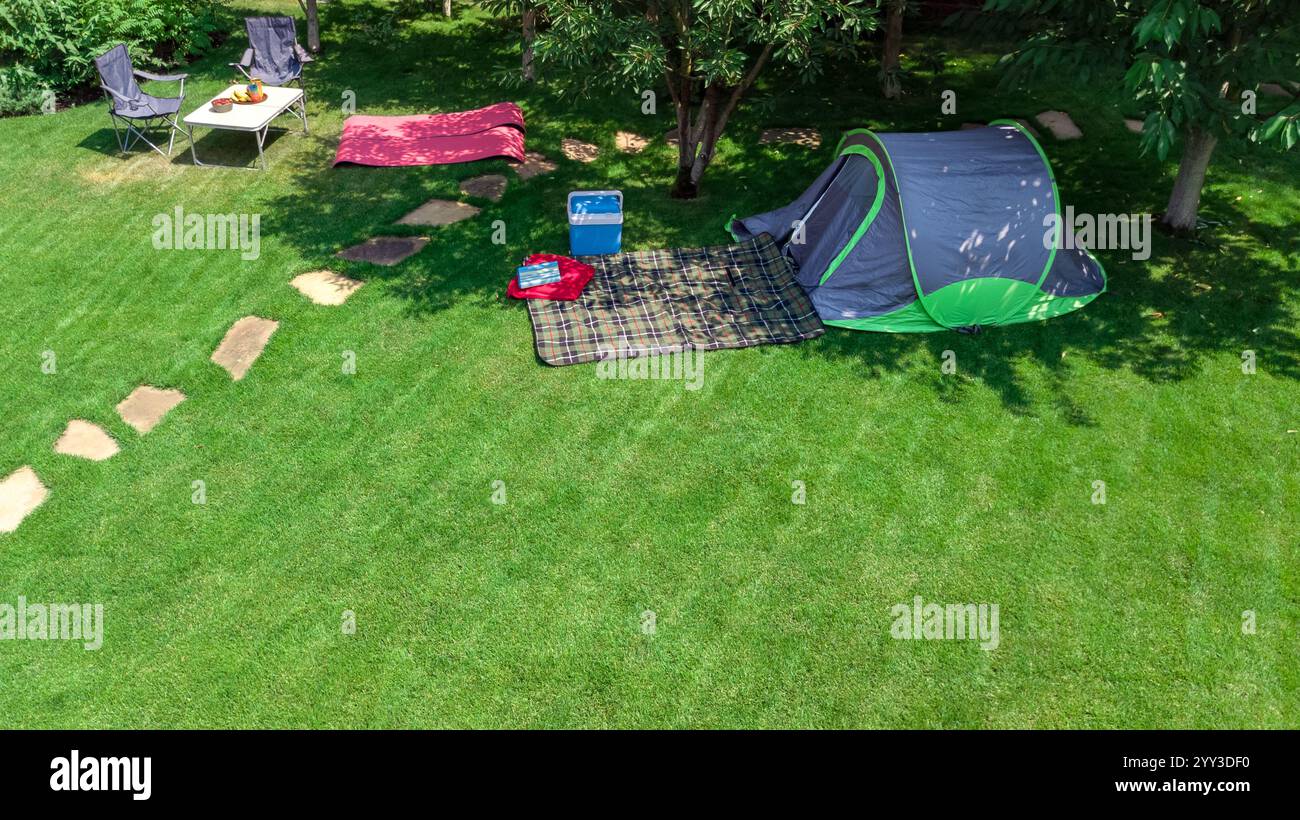 Aerial top view of campsite from above, tent and camping equipment ...
