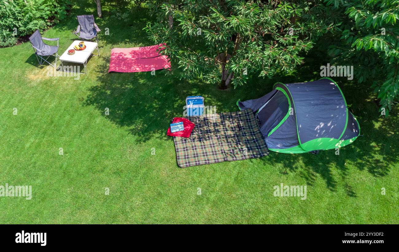 Aerial top view of campsite from above, tent and camping equipment ...