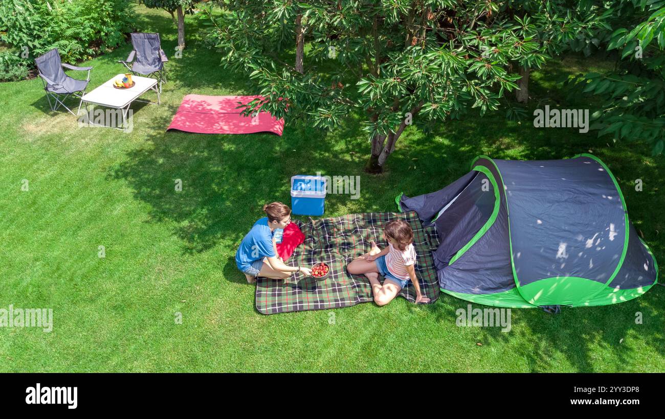 Aerial top view of campsite from above, mother and daughter having fun ...