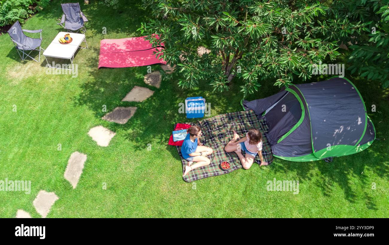 Aerial top view of campsite from above, mother and daughter having fun ...