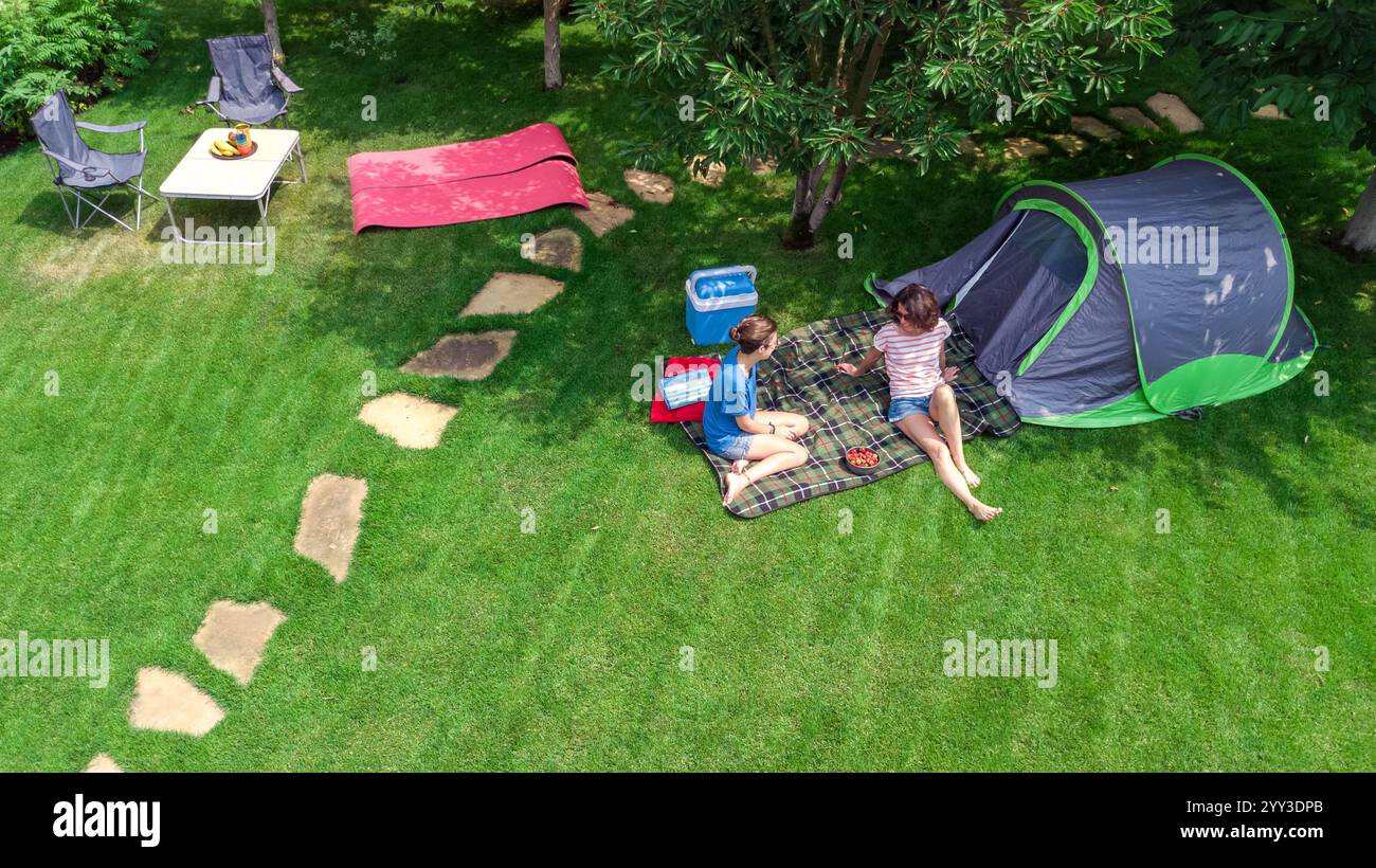 Aerial top view of campsite from above, mother and daughter having fun ...