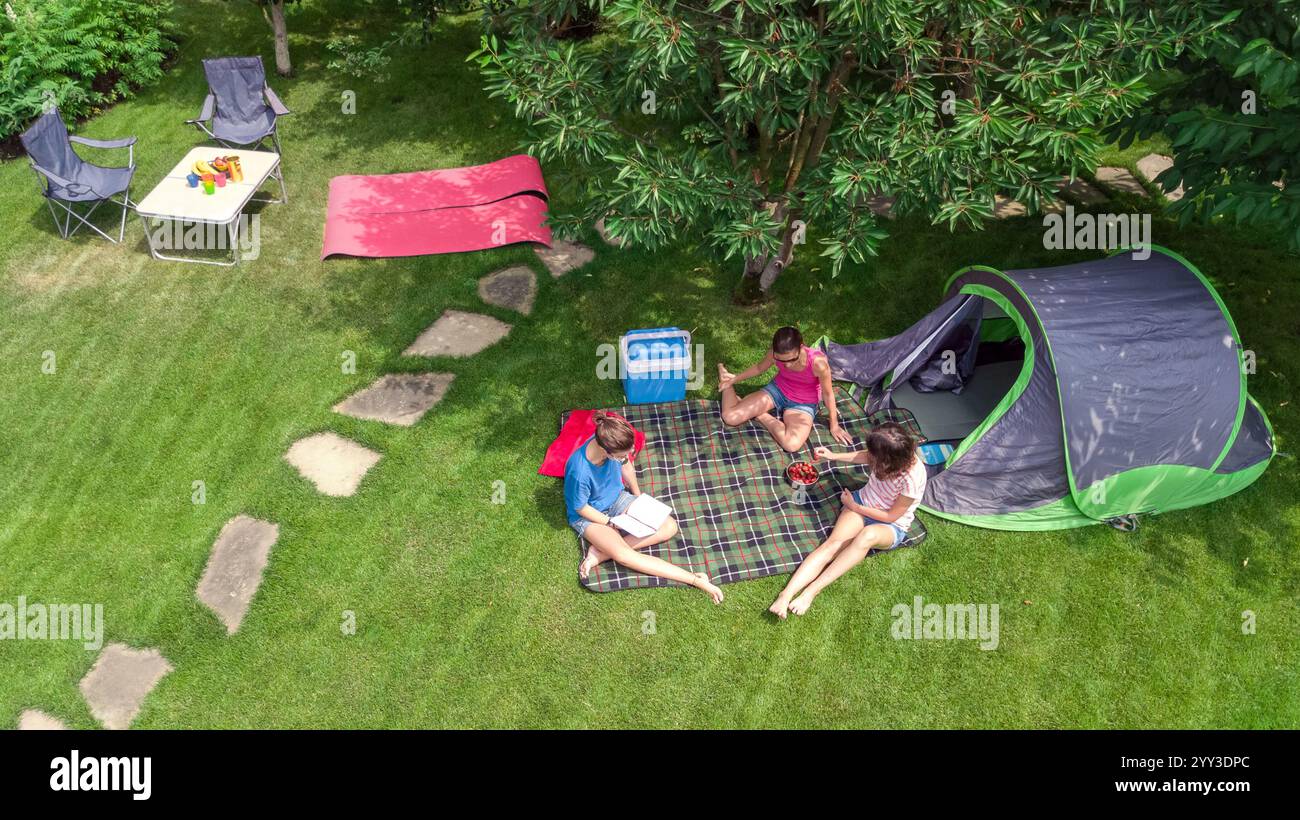 Family vacation in campsite aerial top view from above, parents and ...