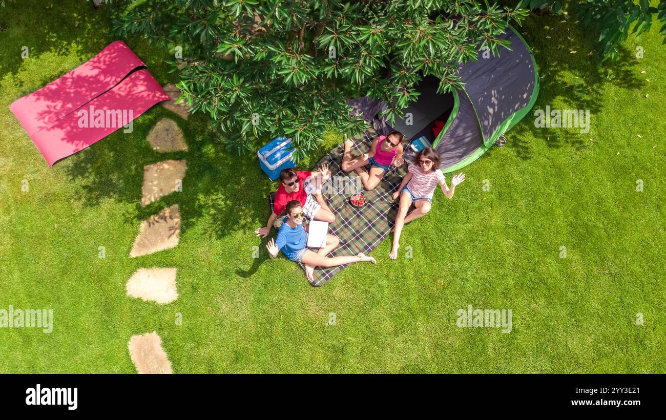 Family vacation in campsite aerial top view from above, parents and ...
