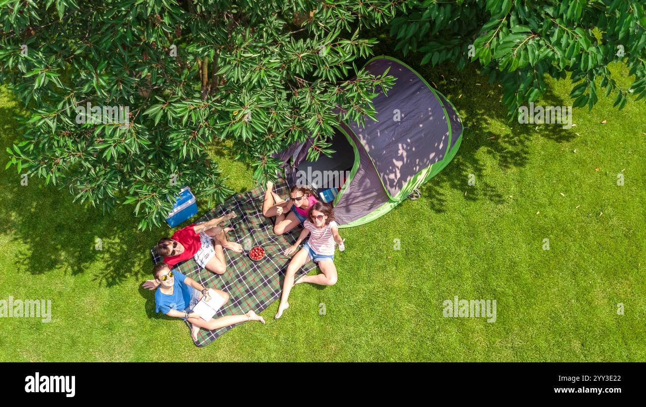 Family vacation in campsite aerial top view from above, parents and ...