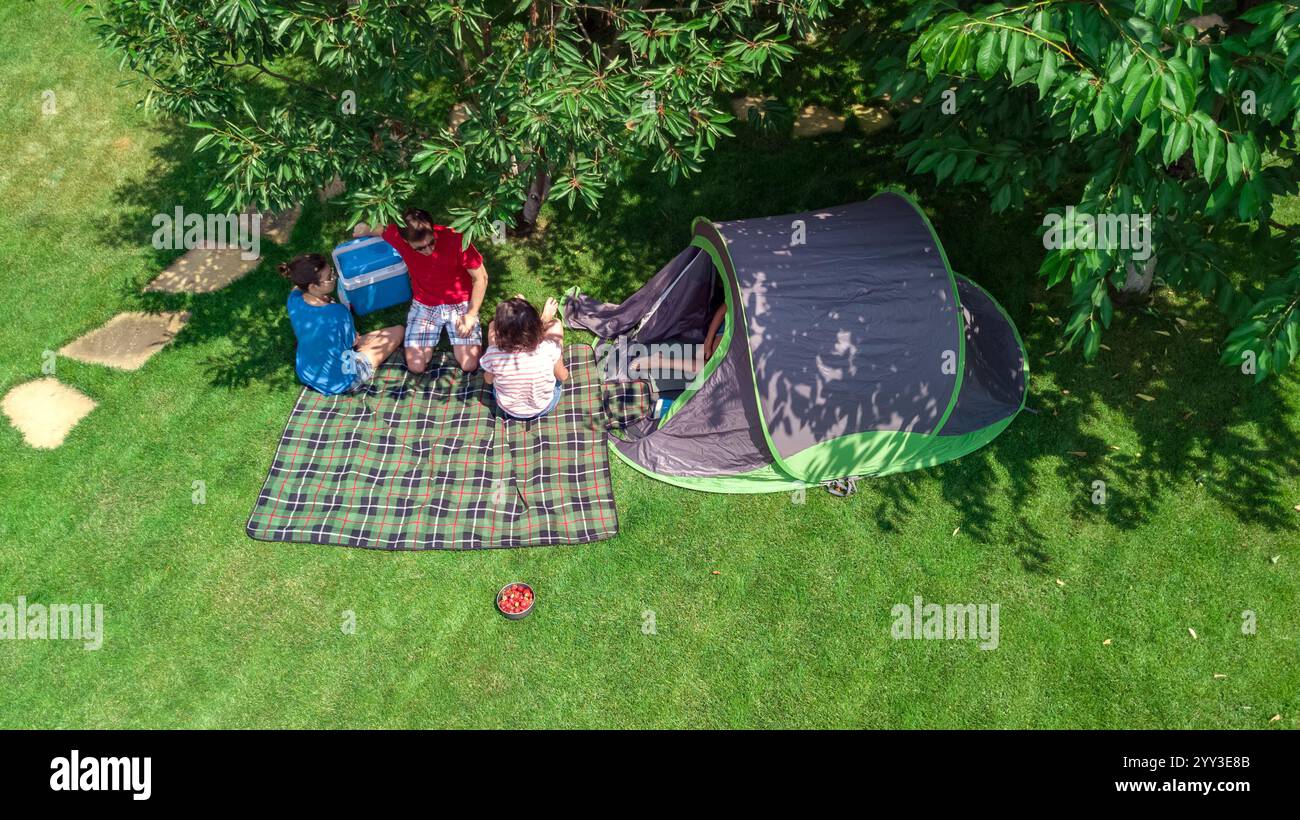 Family vacation in campsite aerial top view from above, parents and ...