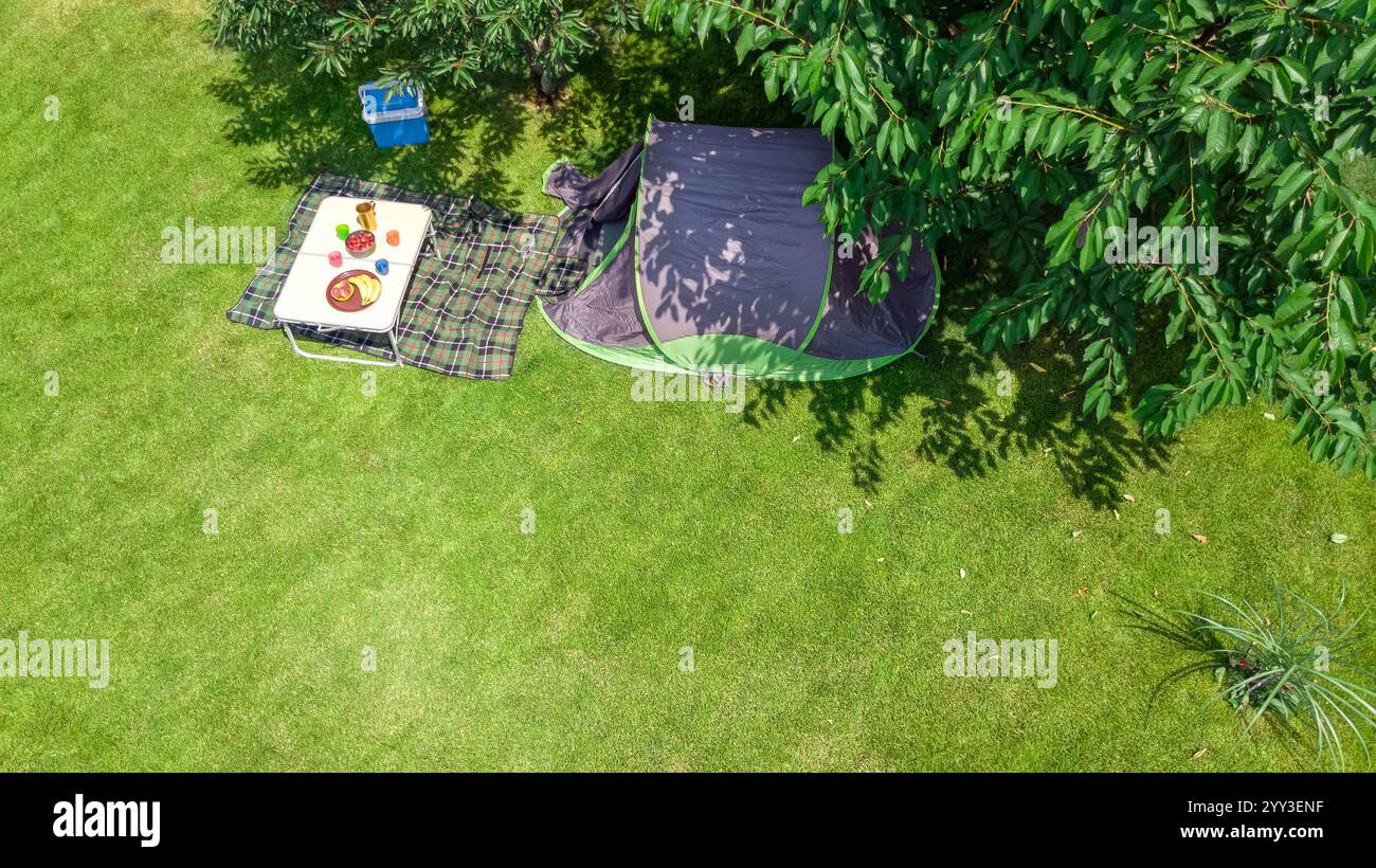 Aerial top view of campsite from above, tent and camping equipment ...
