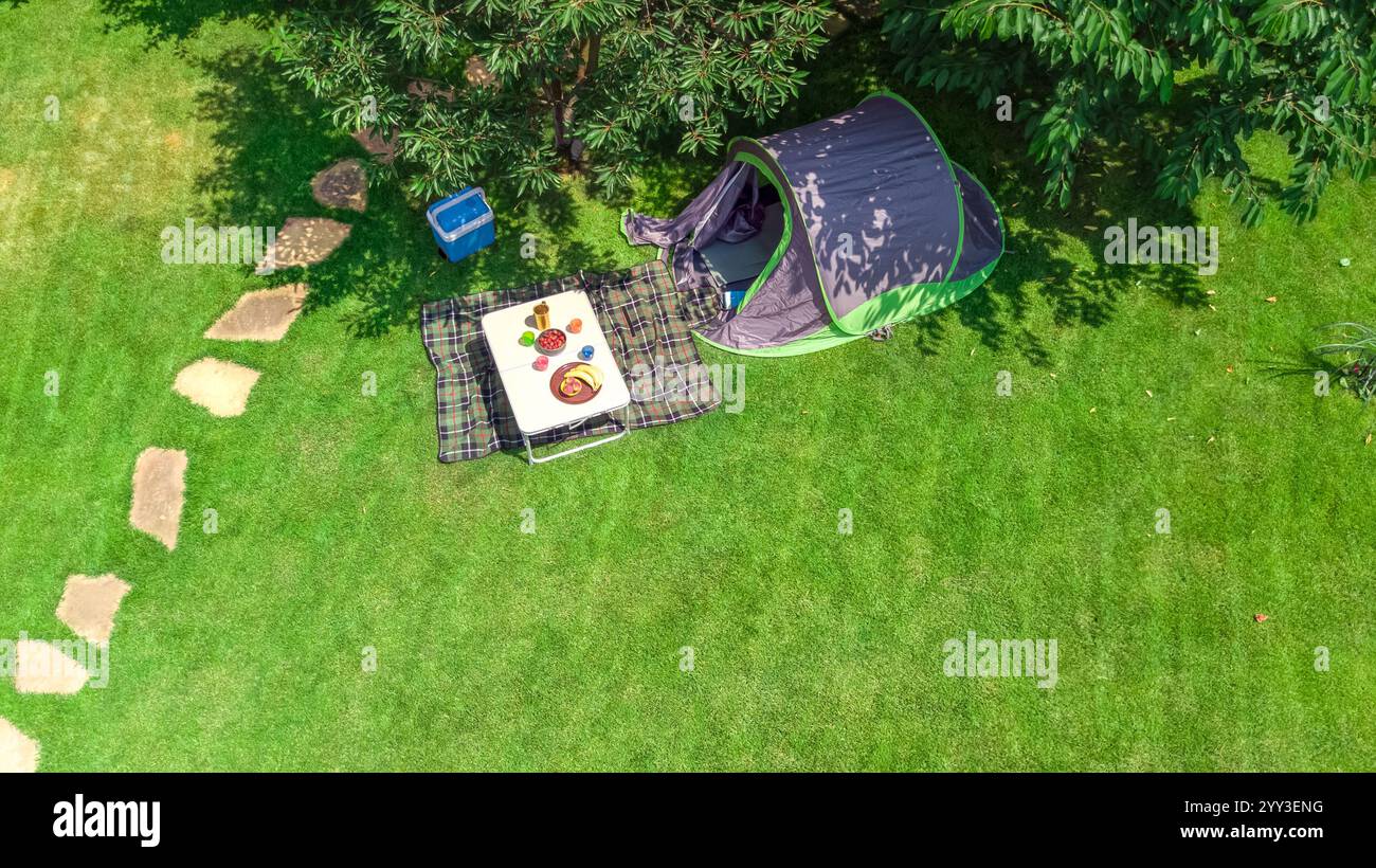 Aerial top view of campsite from above, tent and camping equipment ...
