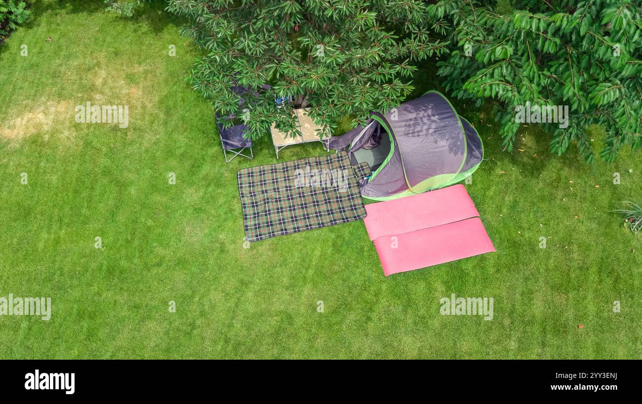 Aerial top view of campsite from above, tent and camping equipment ...