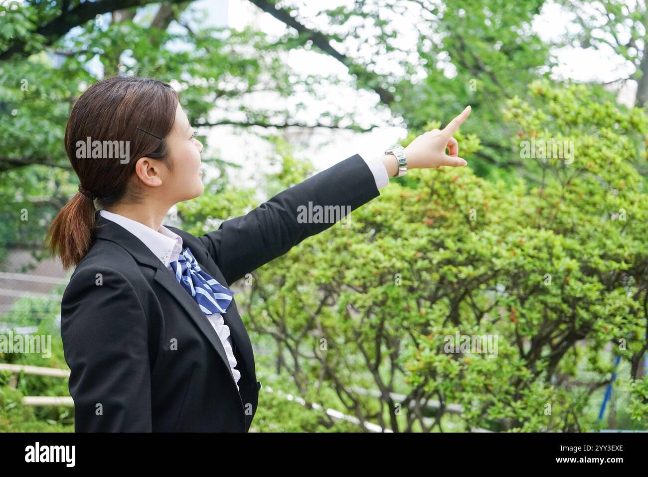 Uniformed student pointing finger Stock Photo - Alamy