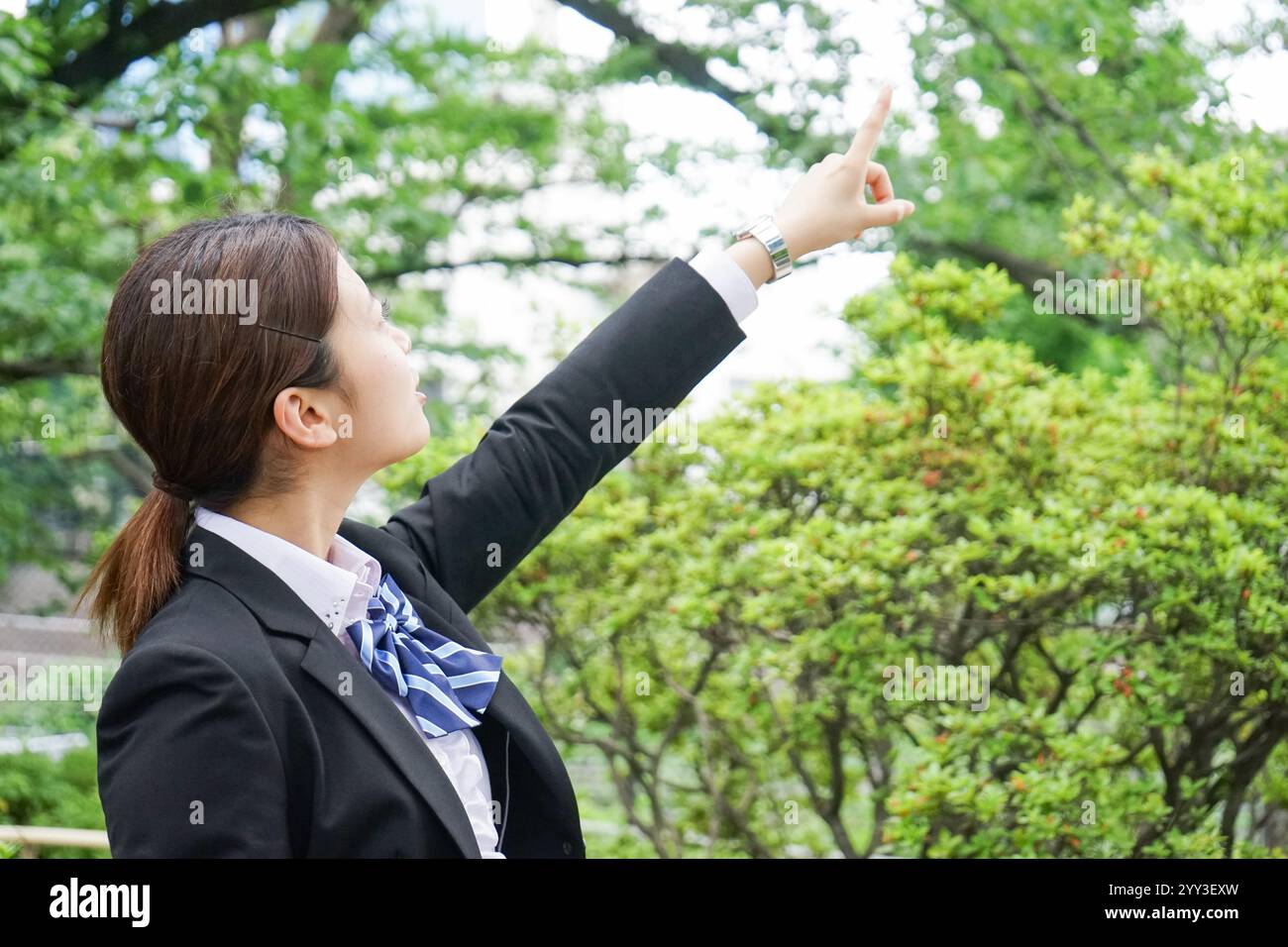 Uniformed student pointing finger Stock Photo - Alamy