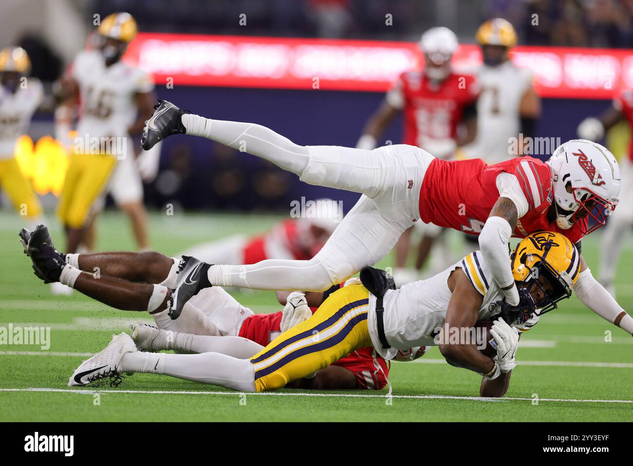California wide receiver Tobias Merriweather, middle, is tackled by ...