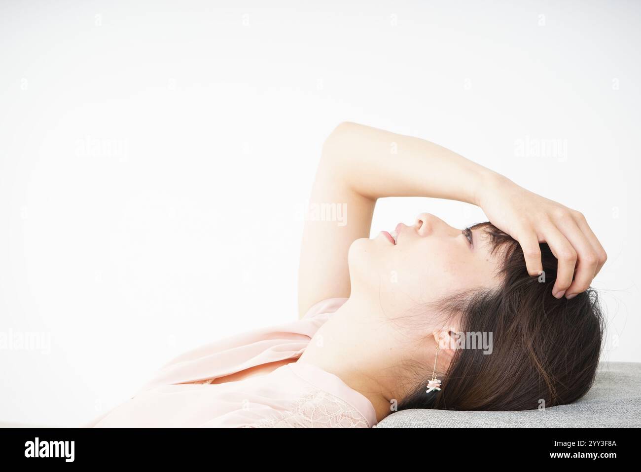 Young woman lying in poor health Stock Photo - Alamy