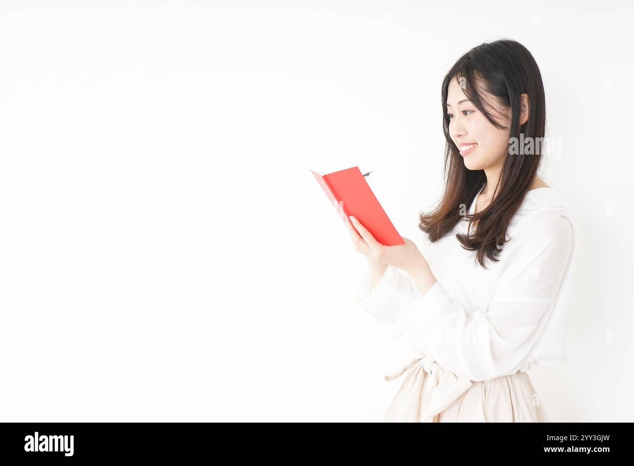 Young woman taking notes Stock Photo - Alamy