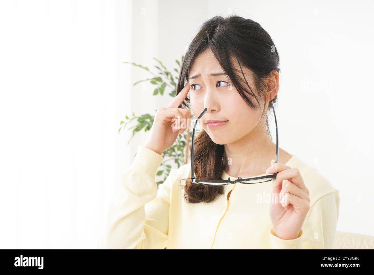 Young woman tired from office work Stock Photo - Alamy
