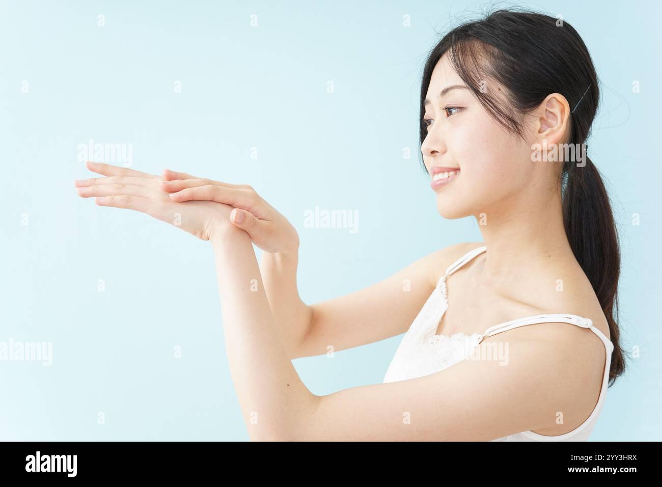 Woman applying hand cream Stock Photo - Alamy