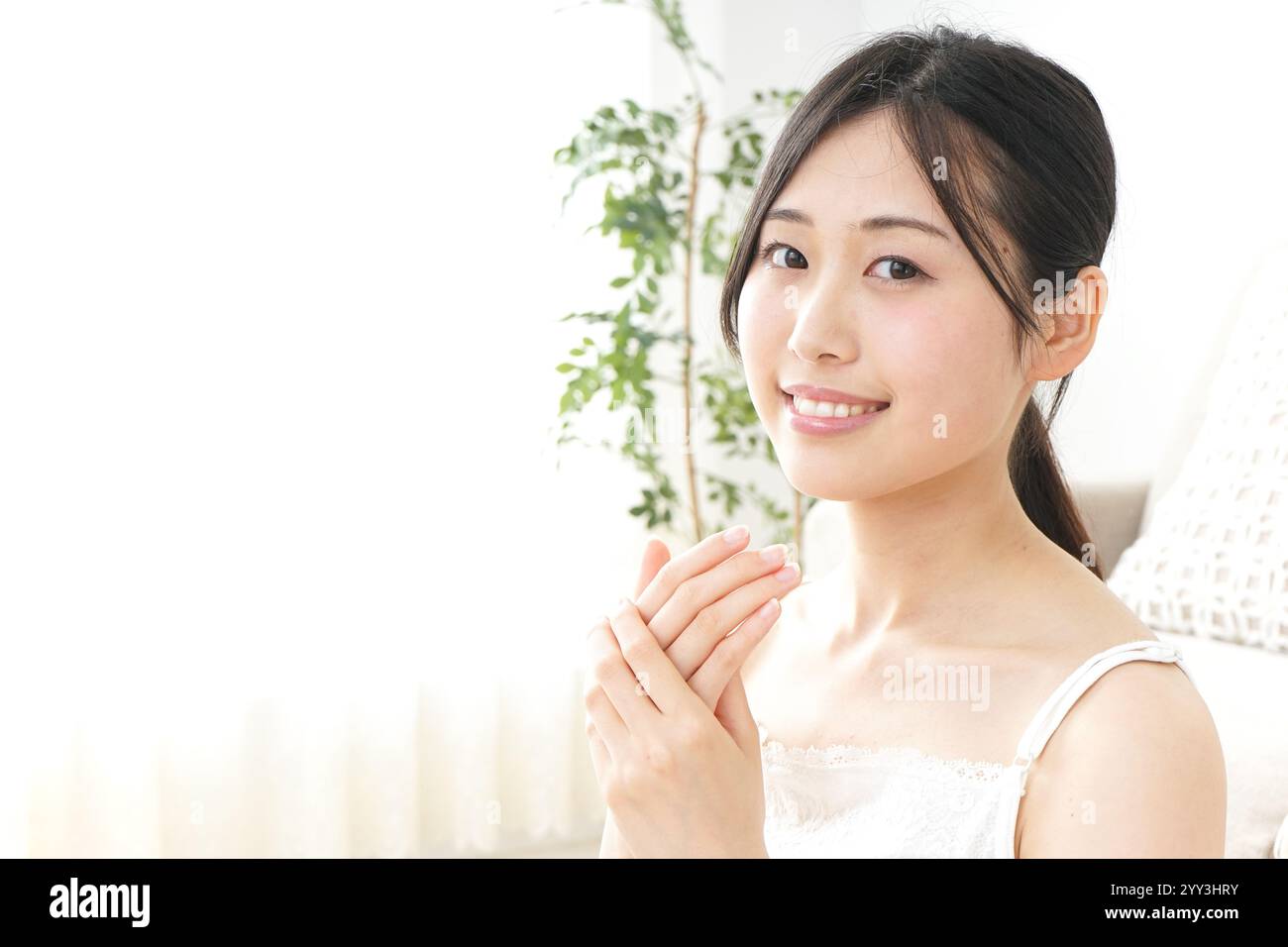 Woman applying hand cream Stock Photo - Alamy