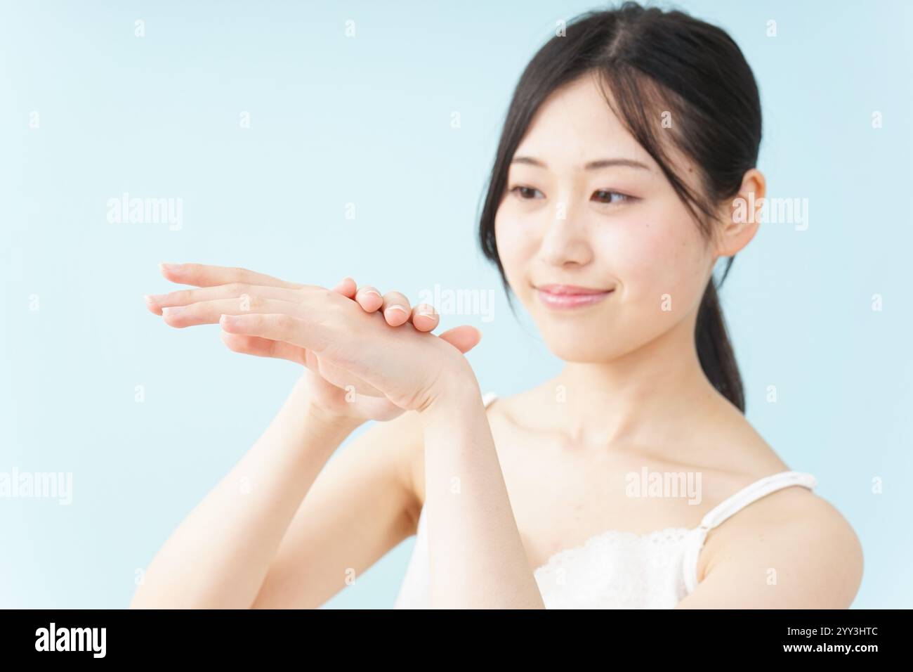 Woman applying hand cream Stock Photo - Alamy