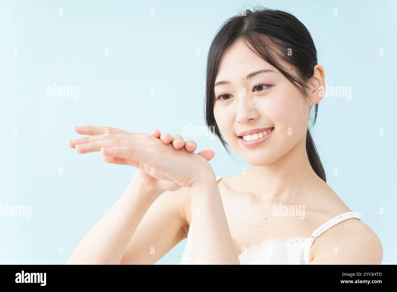 Woman applying hand cream Stock Photo - Alamy