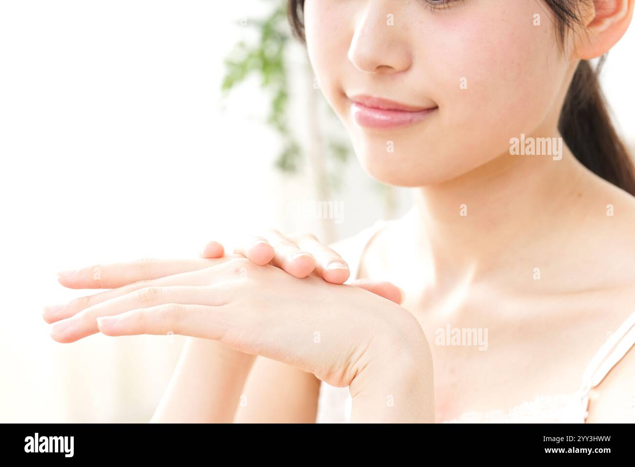 Woman applying hand cream Stock Photo - Alamy