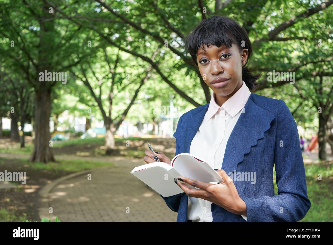 Woman taking notes Stock Photo - Alamy