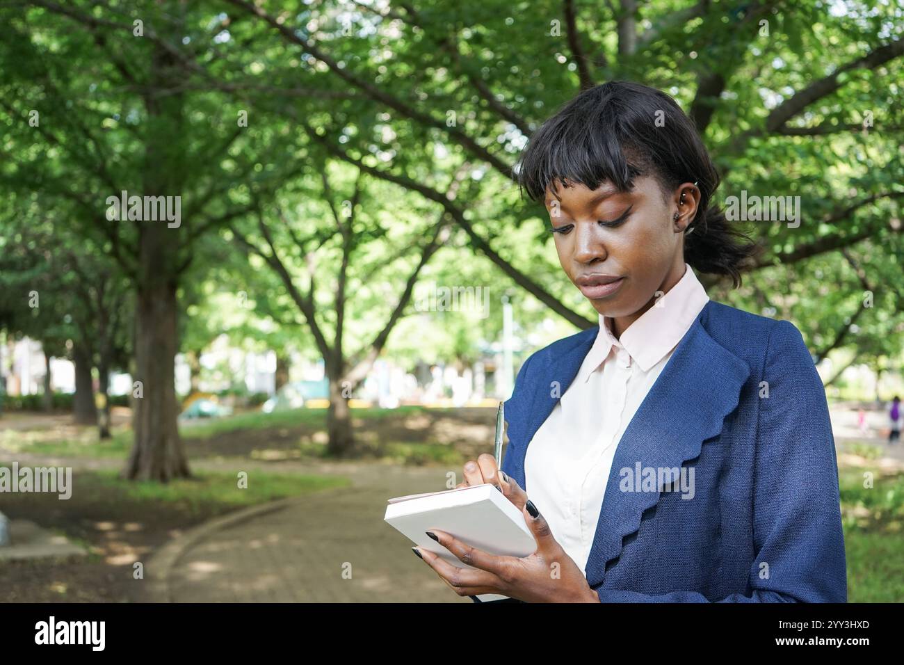 Woman taking notes Stock Photo - Alamy
