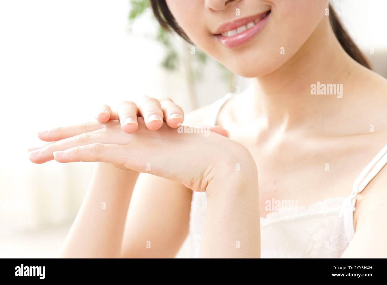 Woman applying hand cream Stock Photo - Alamy