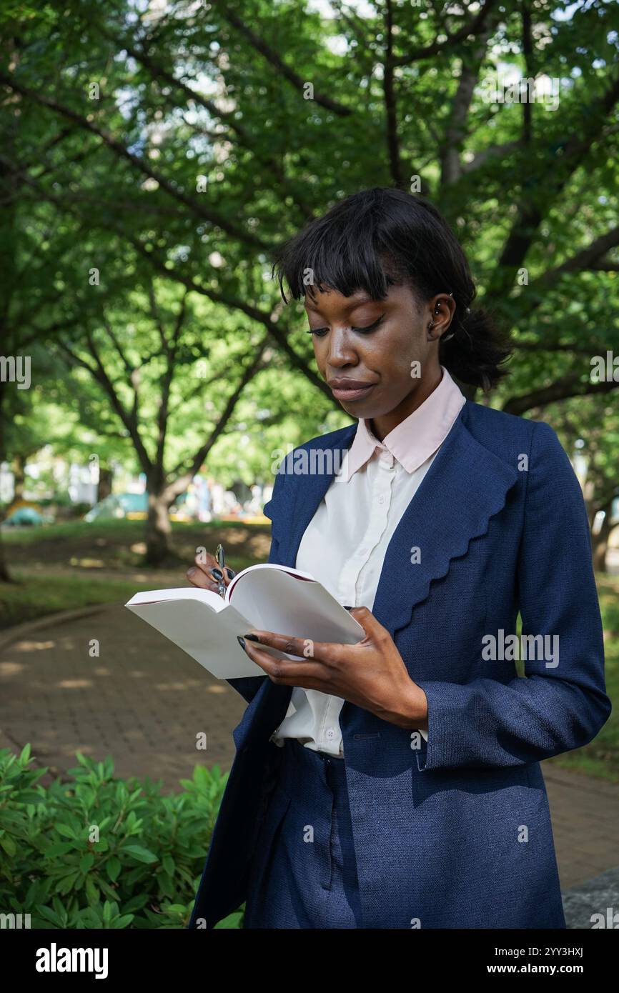 Woman taking notes Stock Photo - Alamy
