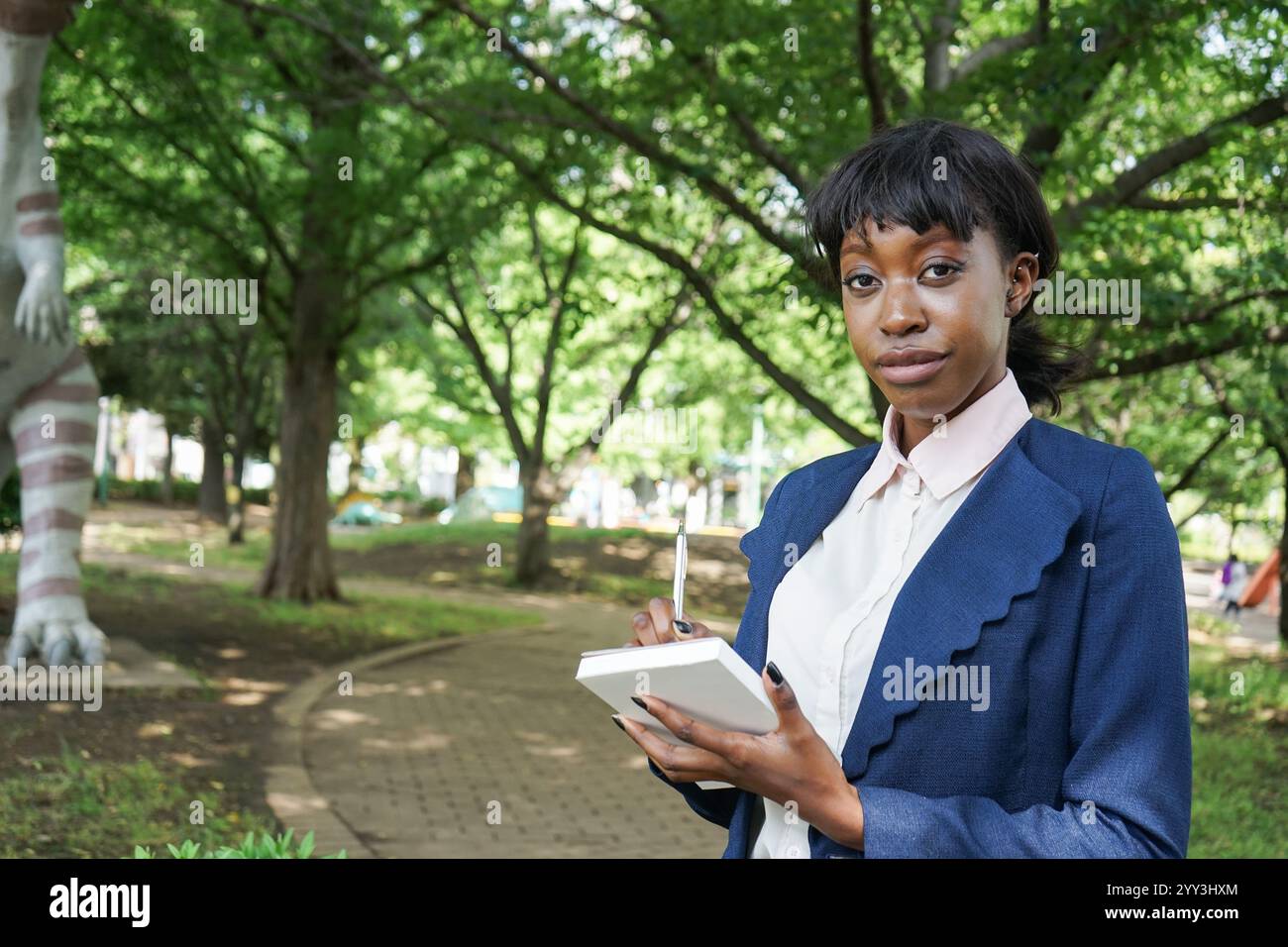 Woman taking notes Stock Photo - Alamy