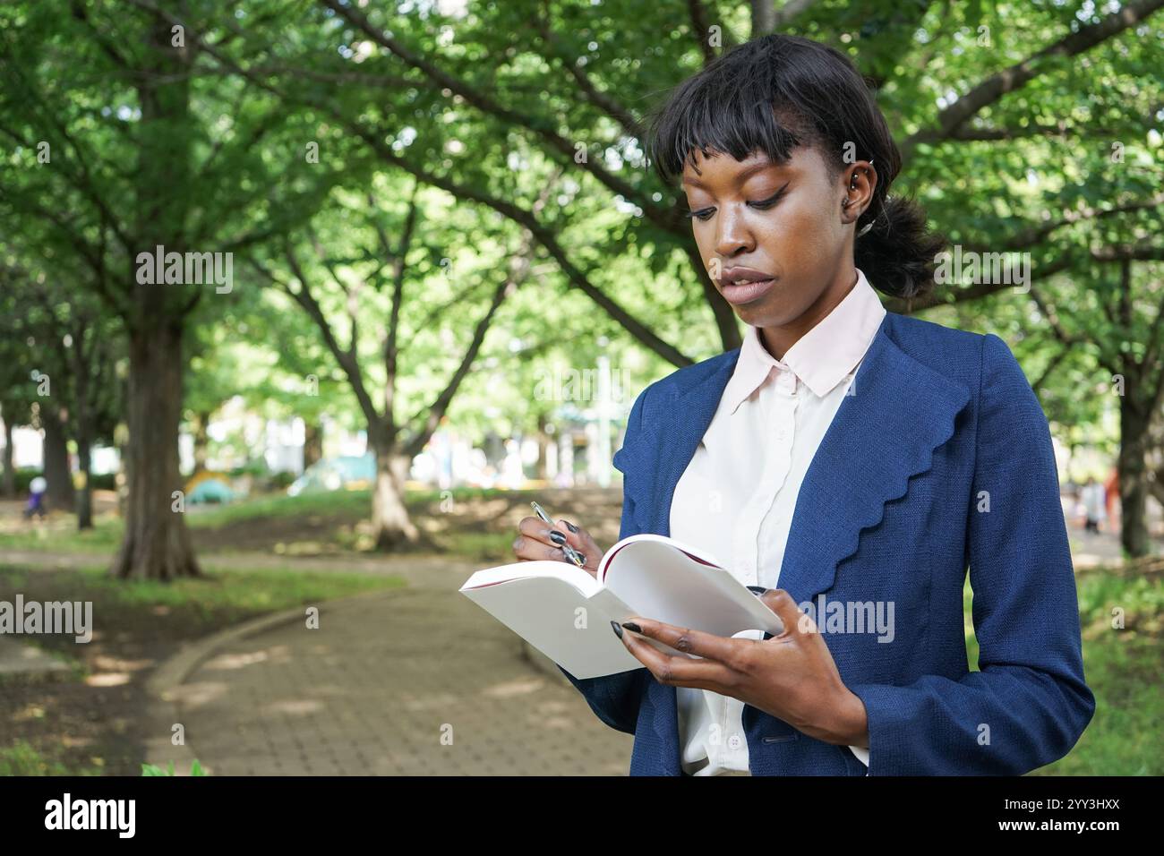 Woman taking notes Stock Photo - Alamy