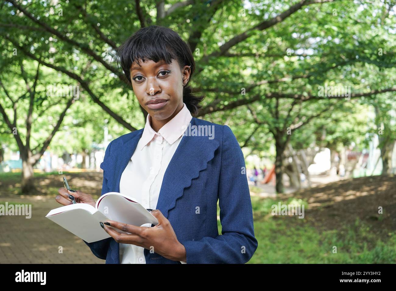 Woman taking notes Stock Photo - Alamy