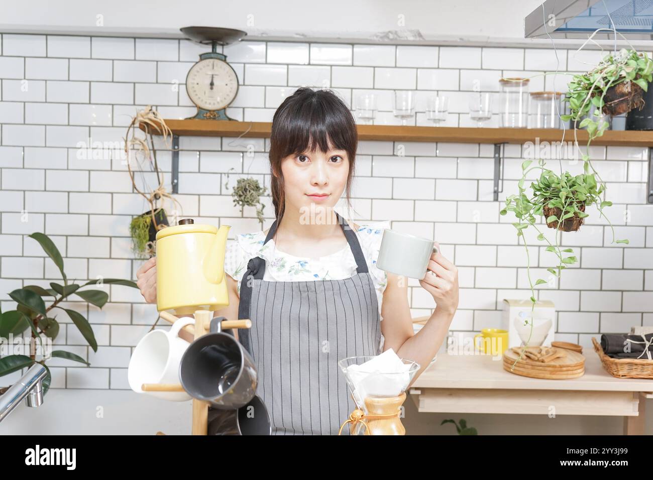 Young woman making drip coffee Stock Photo - Alamy