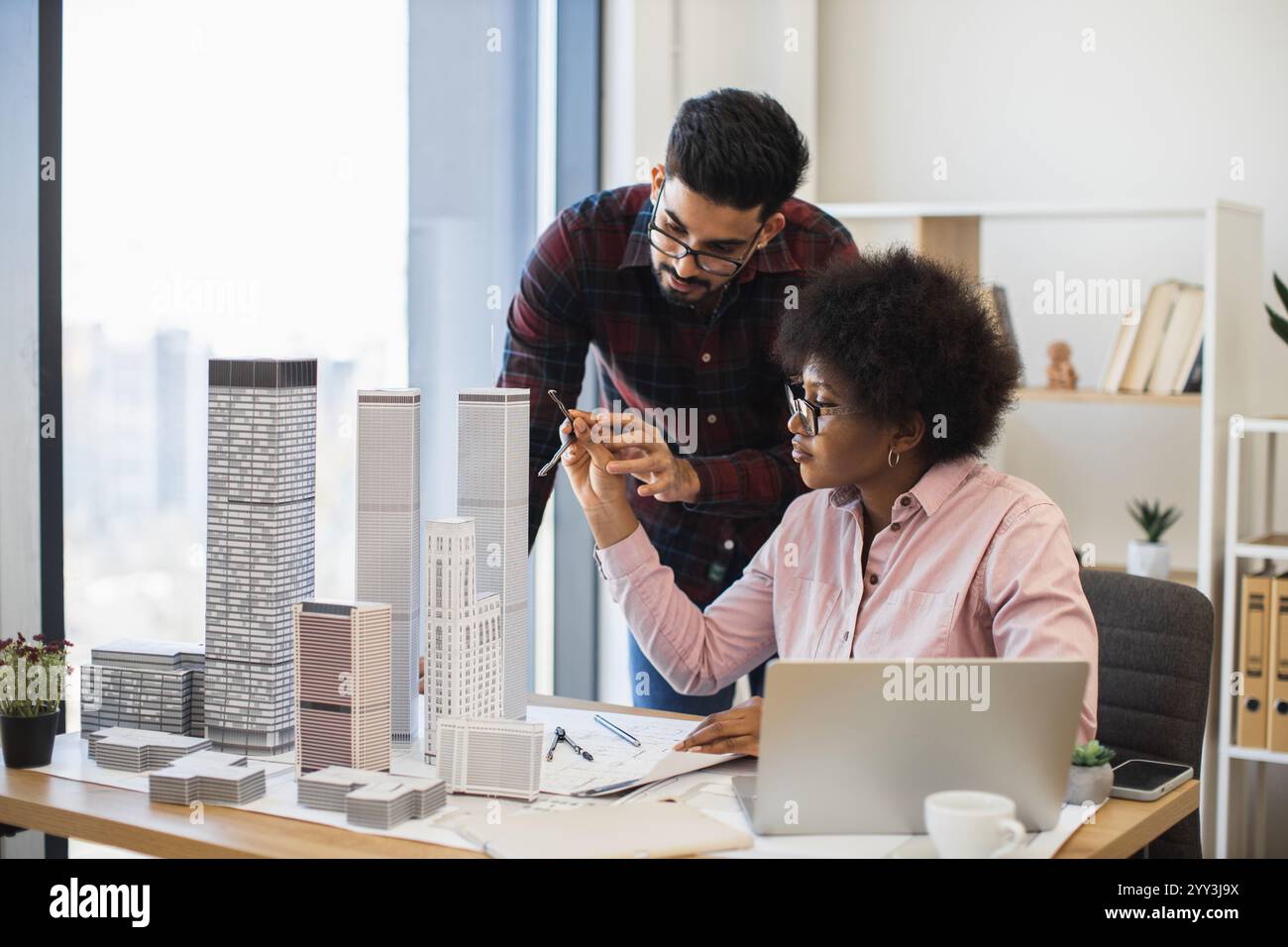 Indian man and African woman architects develop project for modern city model. Focus on ...