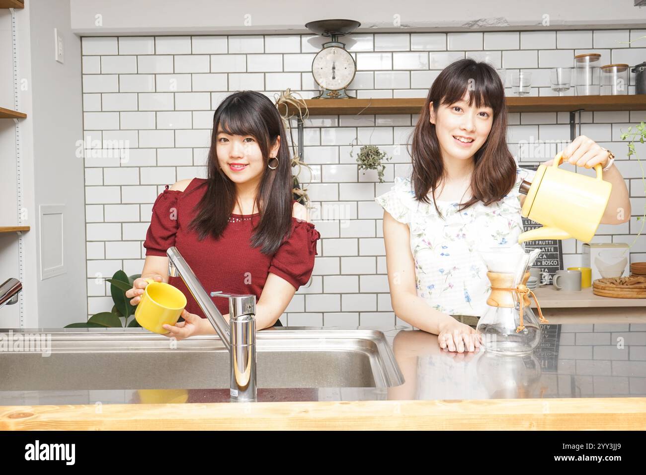 Two women cooking Stock Photo - Alamy
