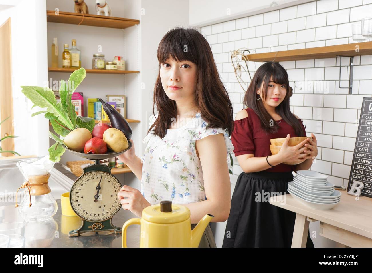 Two women cooking Stock Photo - Alamy