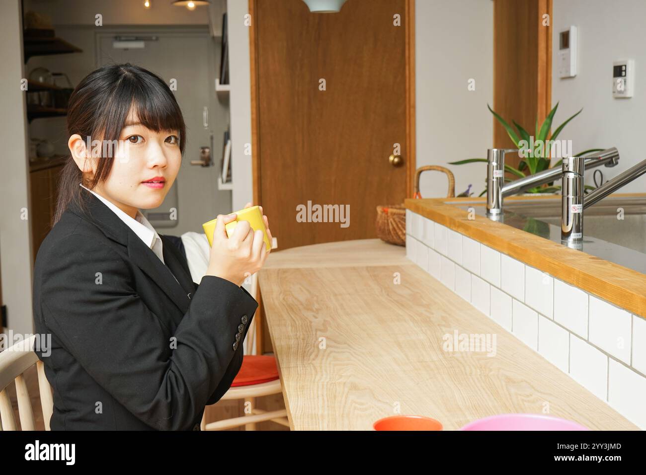 Woman relaxing in a suit Stock Photo - Alamy