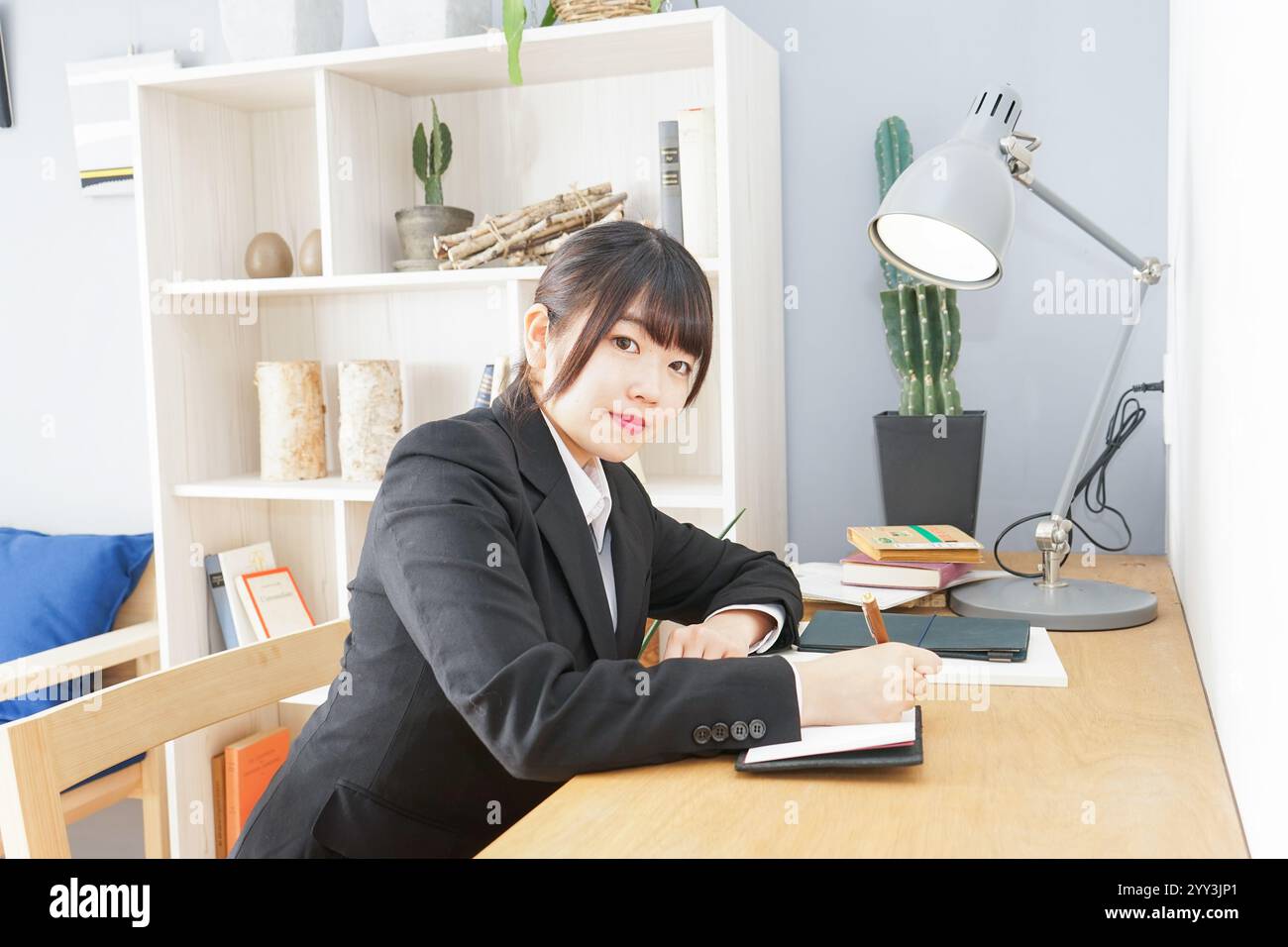 Woman studying in a suit Stock Photo - Alamy