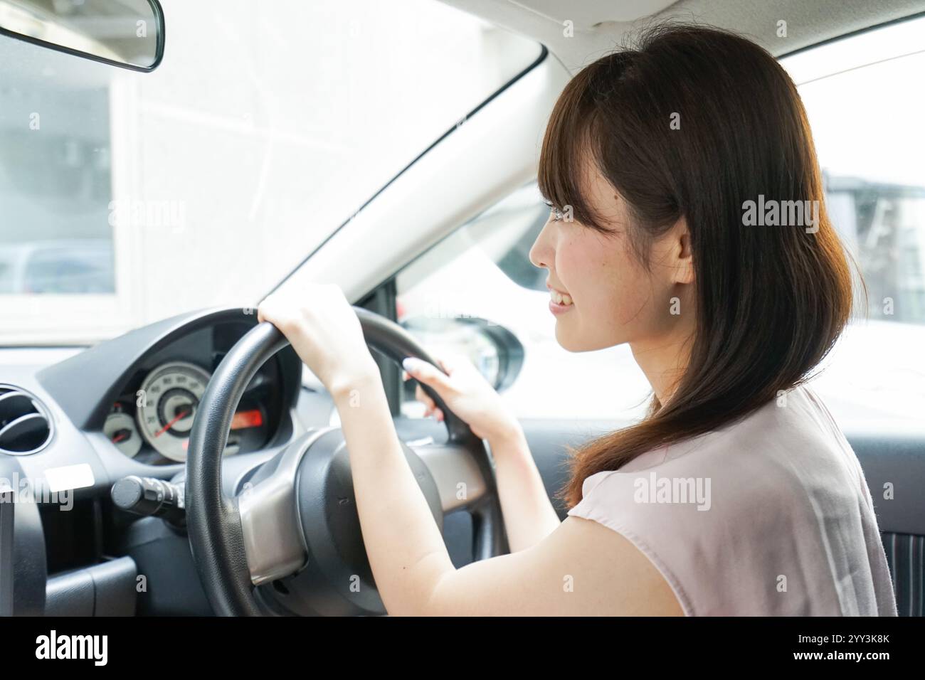 Young Japanese woman driving a car Stock Photo - Alamy