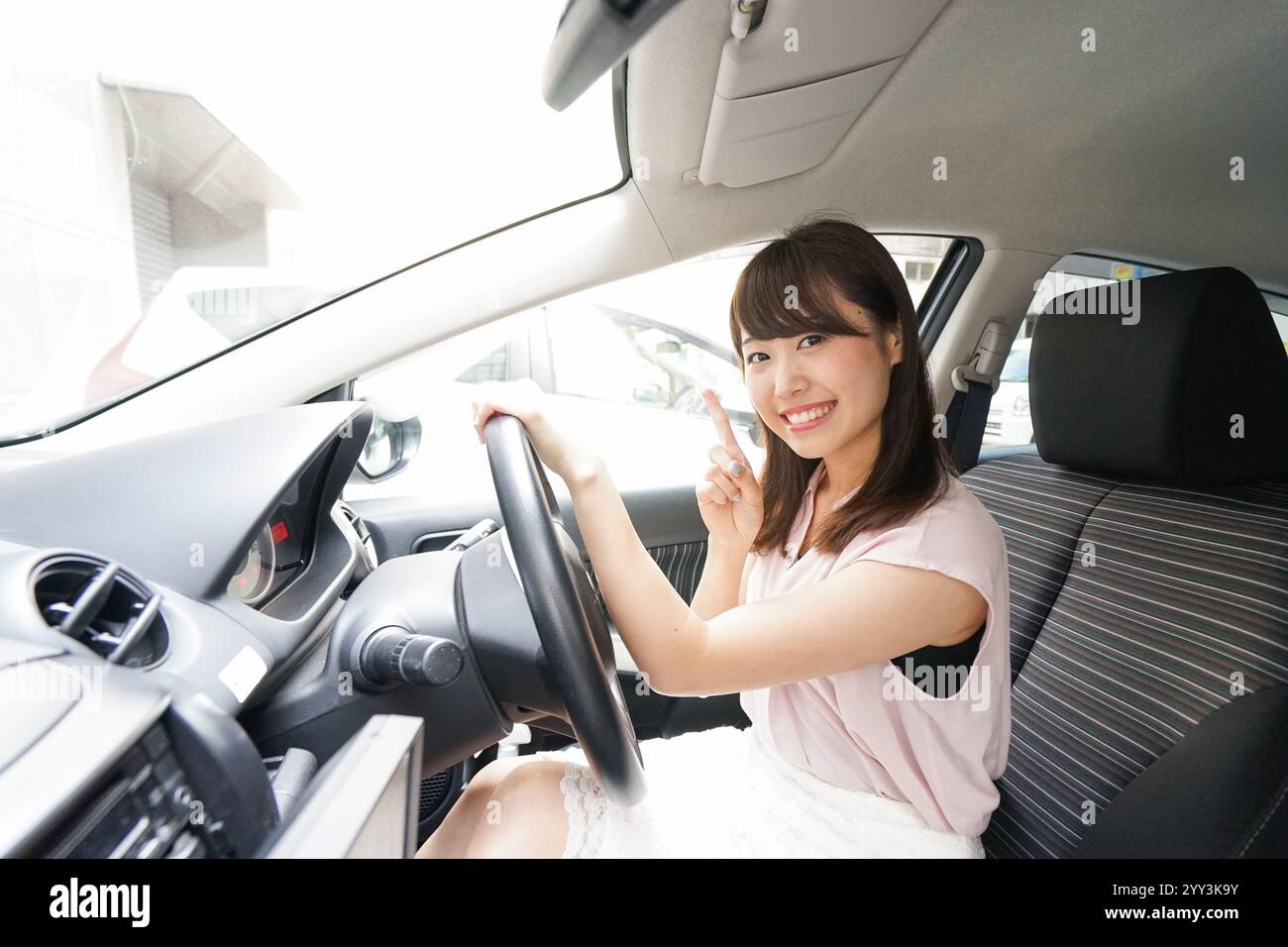 Young Japanese woman driving a car Stock Photo - Alamy
