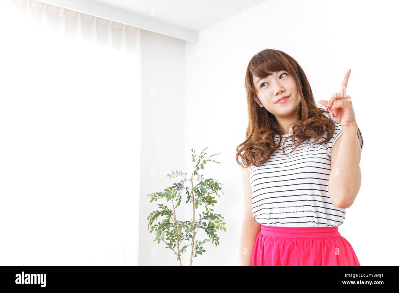 Woman pointing finger Stock Photo - Alamy