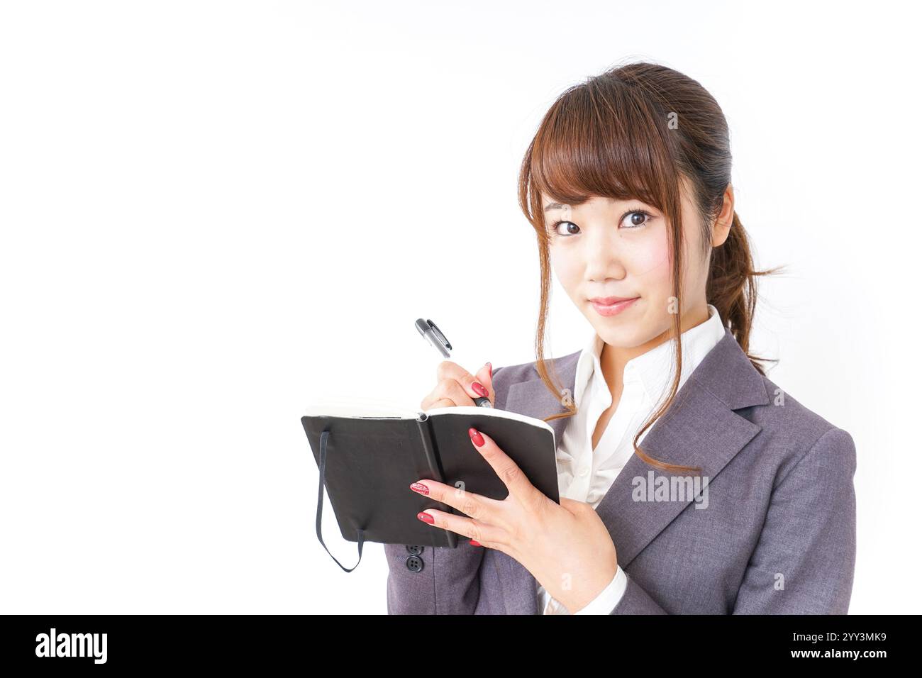Business woman taking notes Stock Photo - Alamy