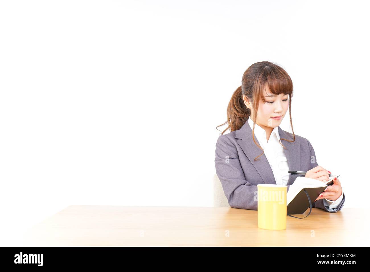 Business woman taking notes Stock Photo - Alamy