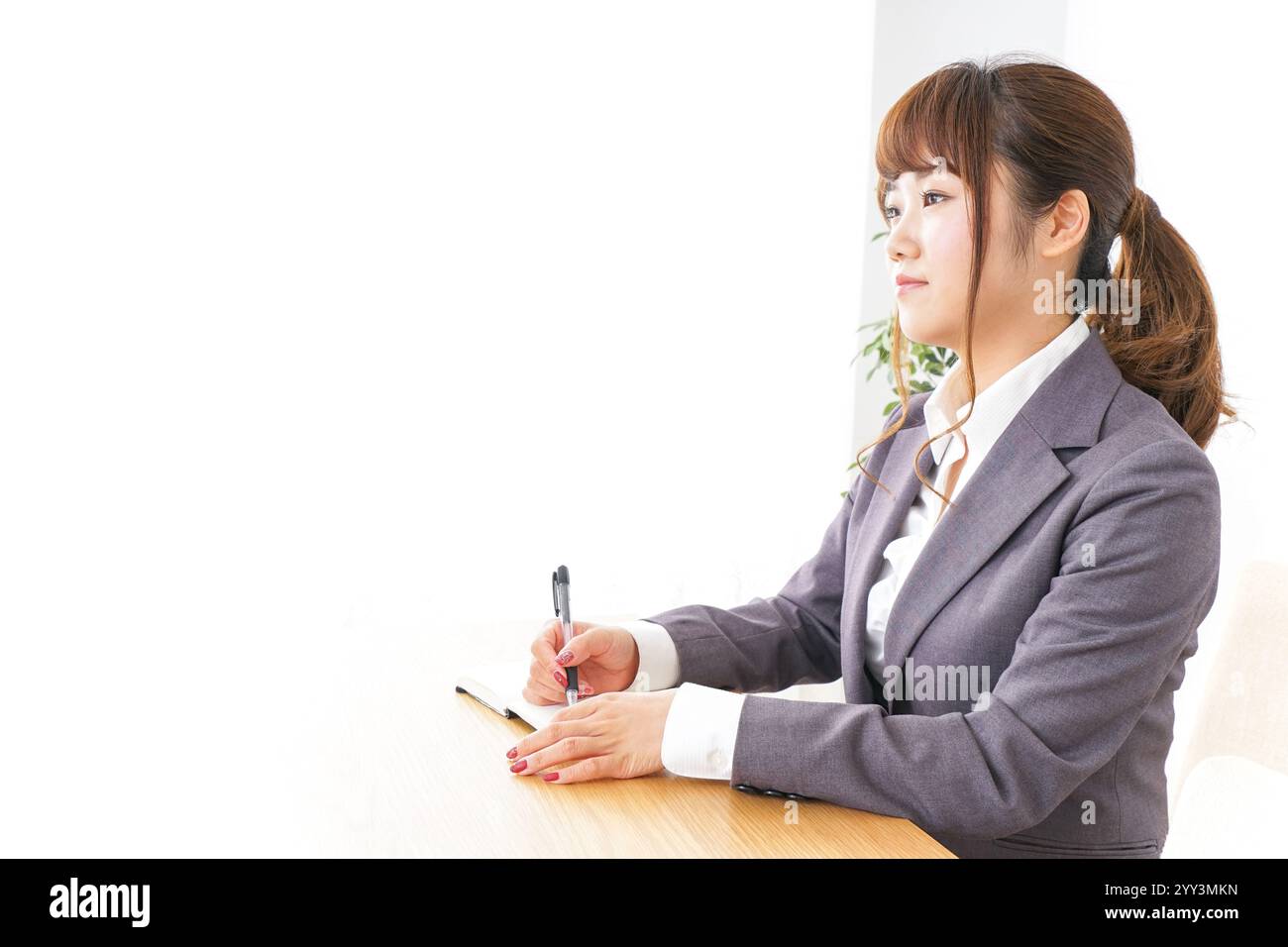Business woman taking notes Stock Photo - Alamy
