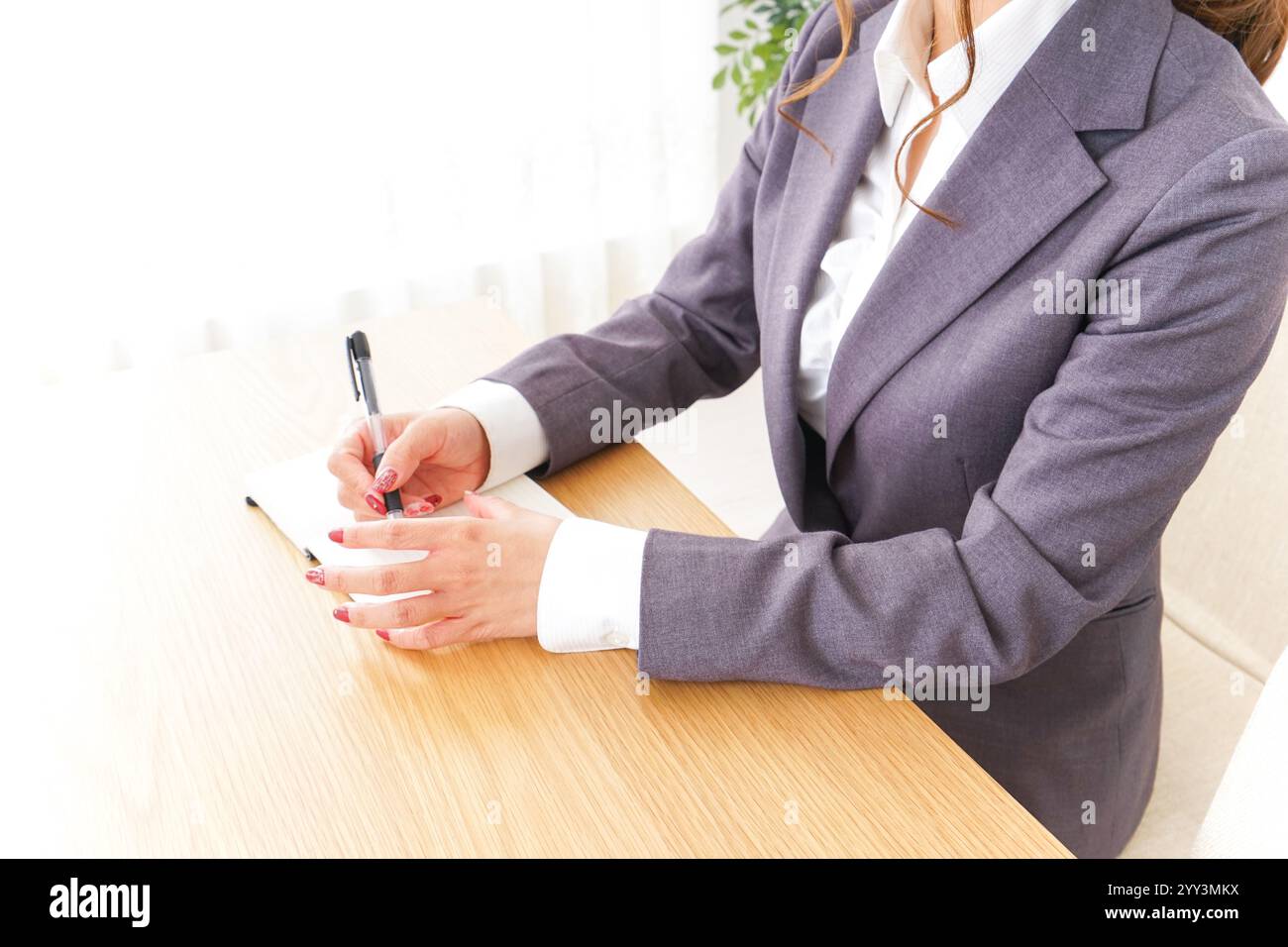 Business woman taking notes Stock Photo - Alamy