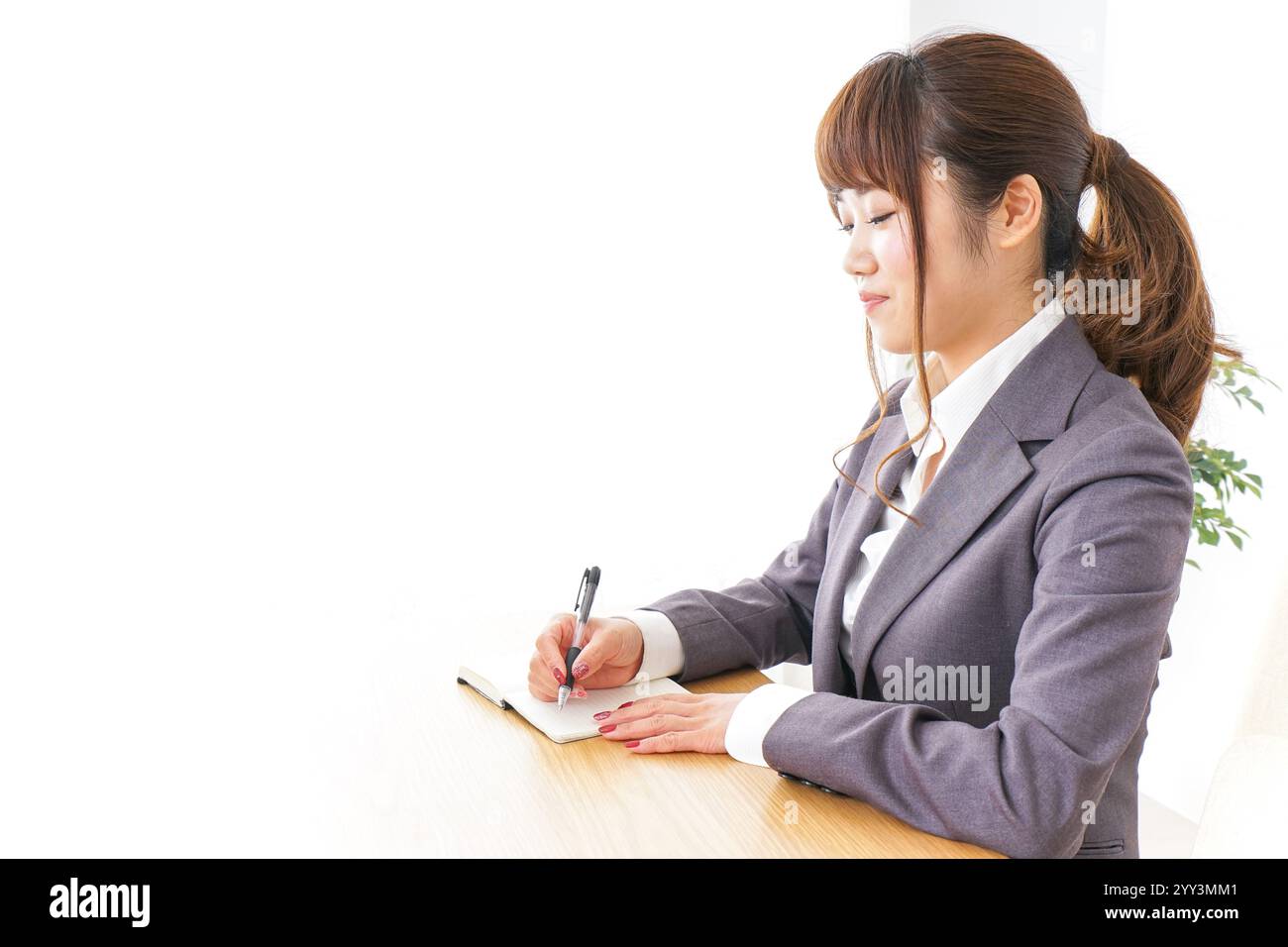 Business woman taking notes Stock Photo - Alamy