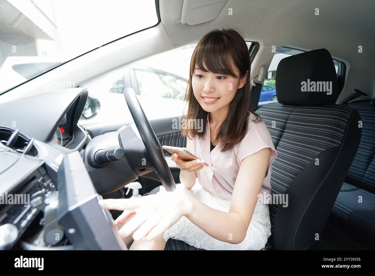 Woman using car navigation system Stock Photo - Alamy