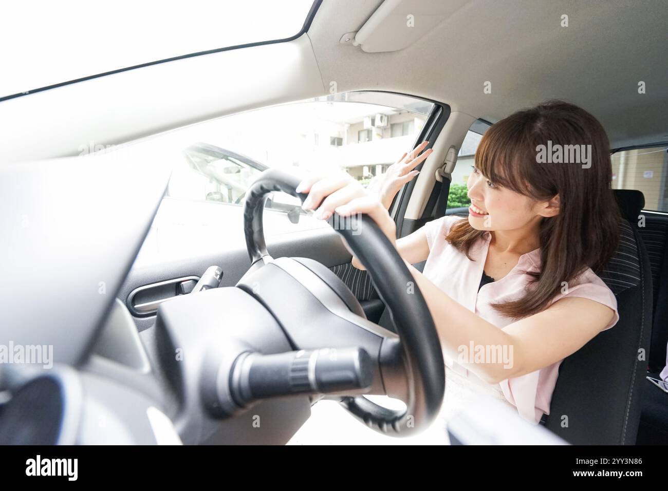 Female driver waving hi-res stock photography and images - Alamy