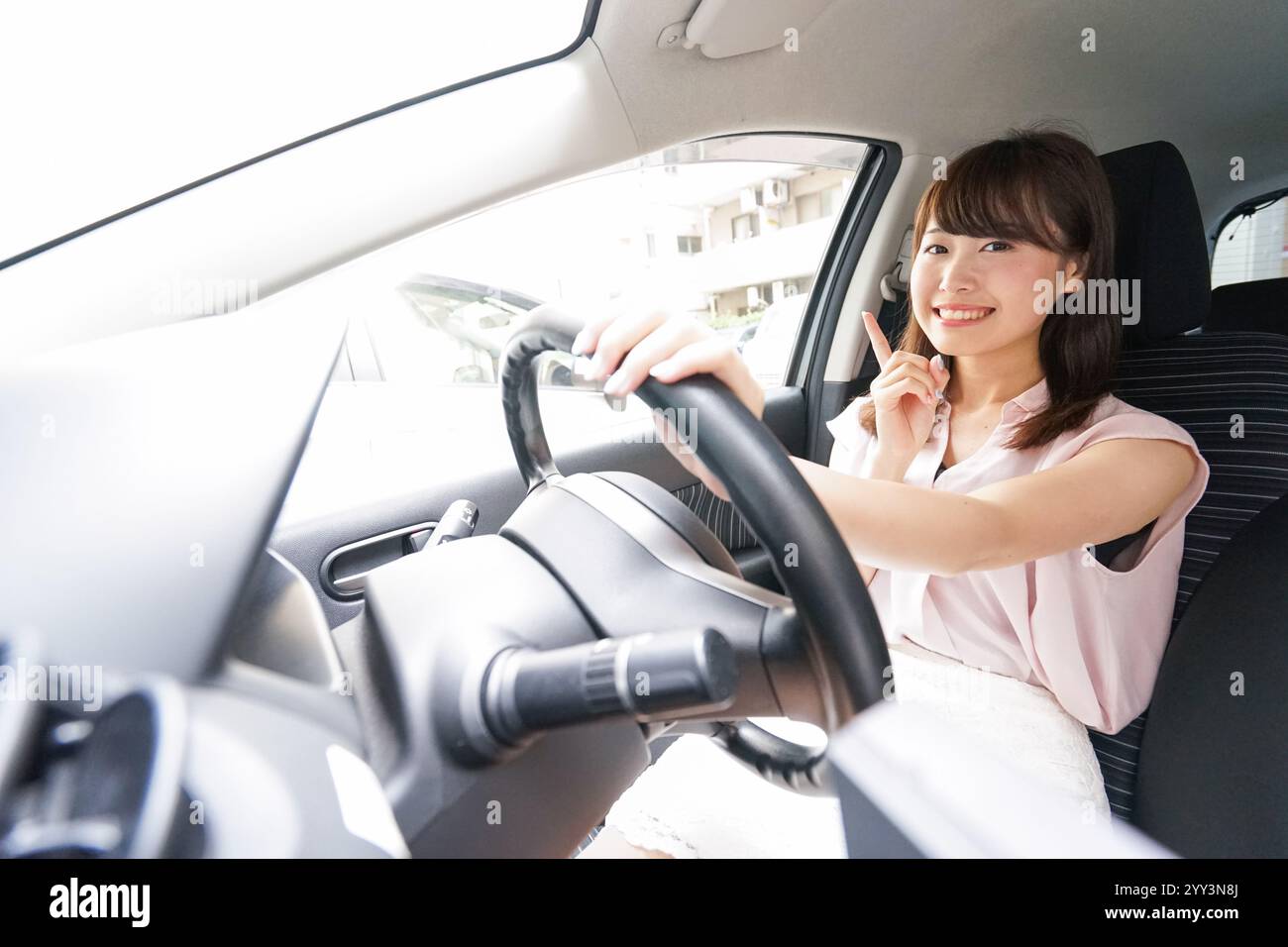Female driver pointing finger Stock Photo - Alamy