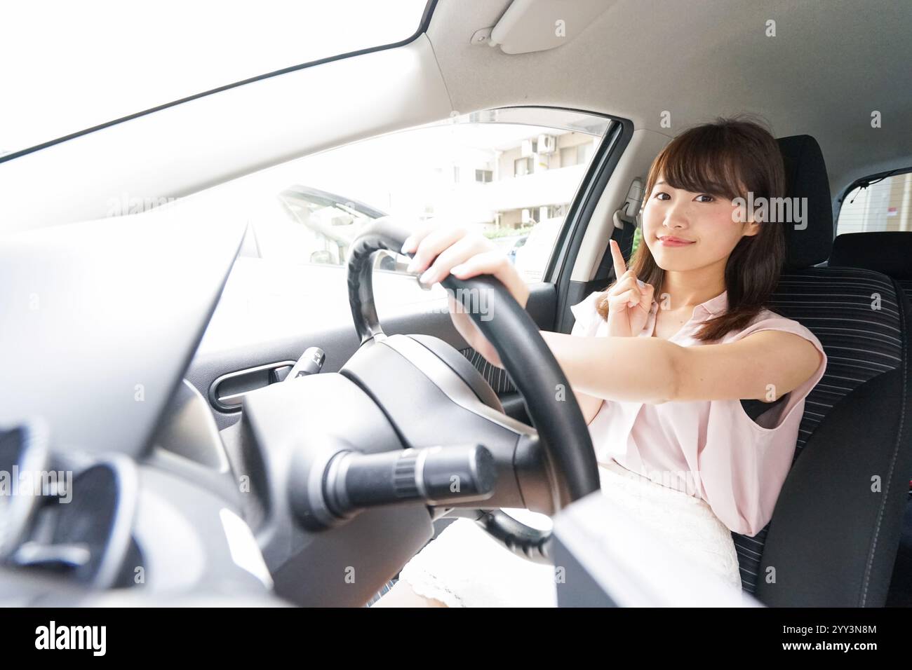 Female driver pointing finger Stock Photo - Alamy