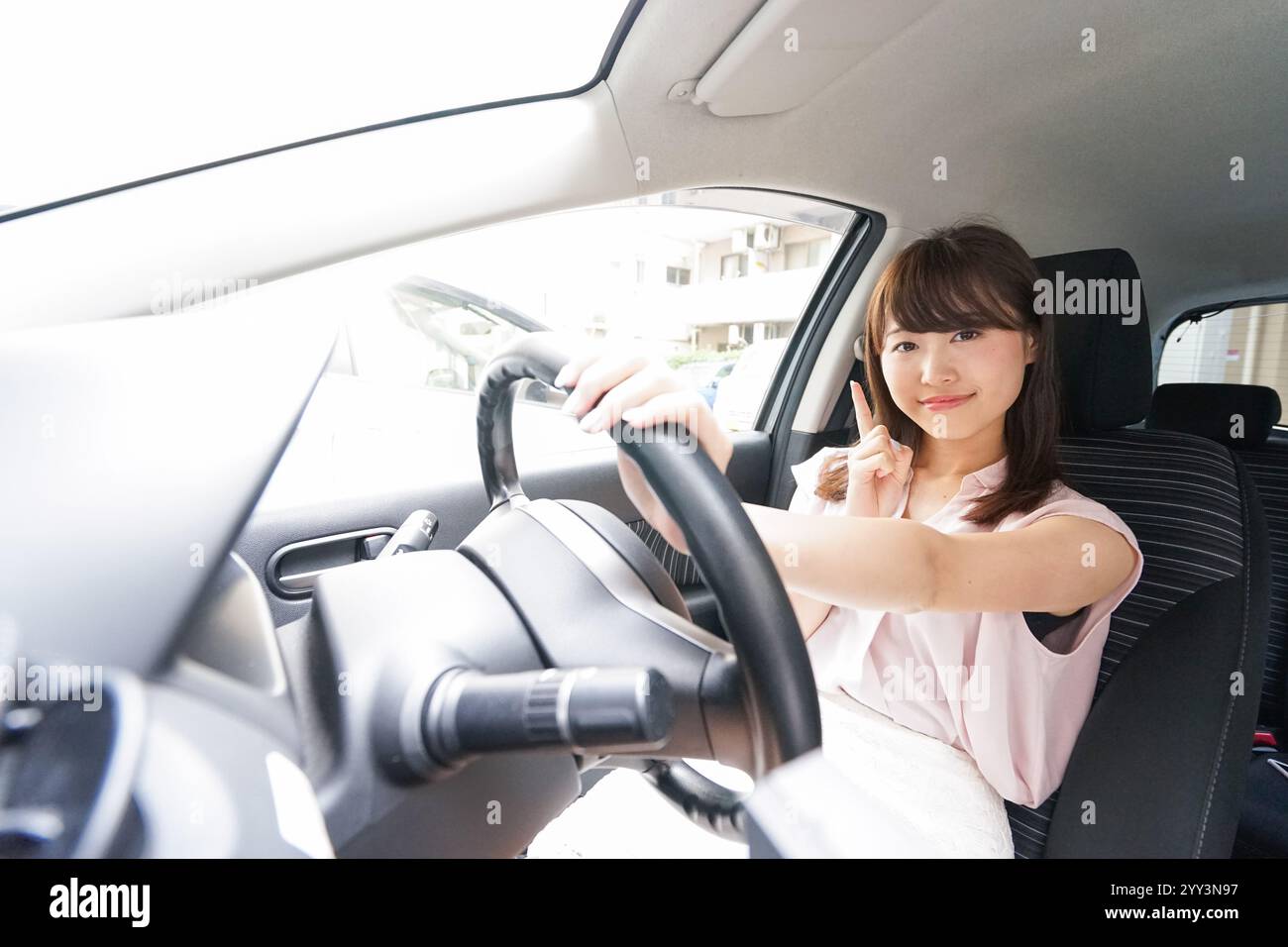 Female driver pointing finger Stock Photo - Alamy