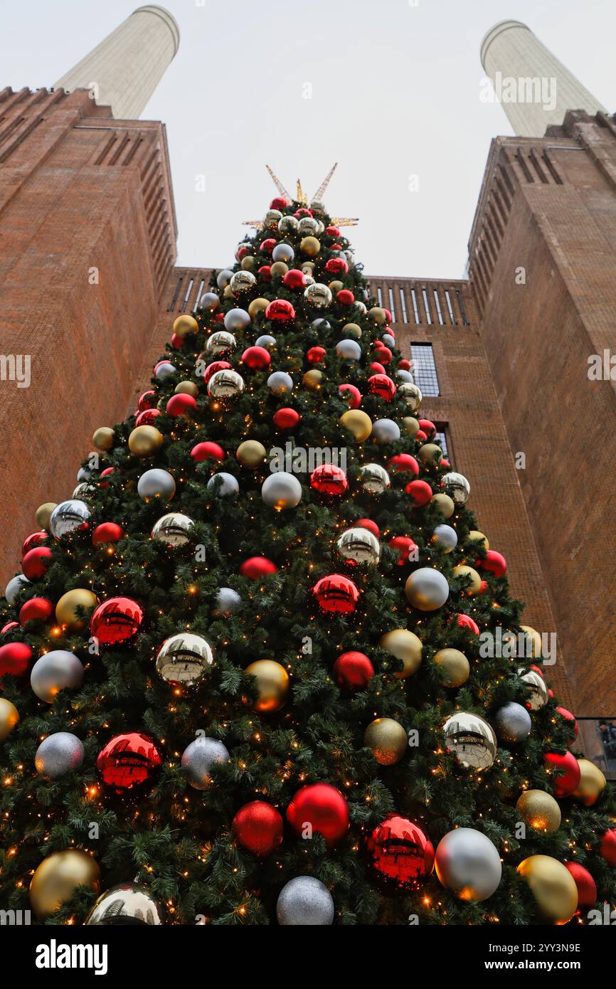 Christmas tree and south facade of Battersea Power Station London UK ...